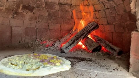 Cooking real pizza in a brick oven. Wood... | Stock Video | Pond5