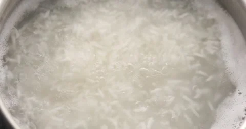 Cooking rice. Close-up of boiling water ... | Stock Video | Pond5