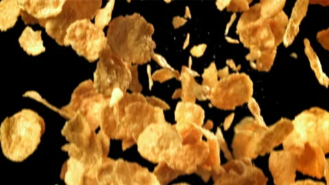 Corn flakes falling on black background.... | Stock Video | Pond5