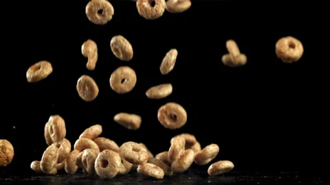 Corn flakes falling on black background.... | Stock Video | Pond5