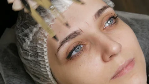 Corrects the shape of eyebrows with a sp... | Stock Video | Pond5