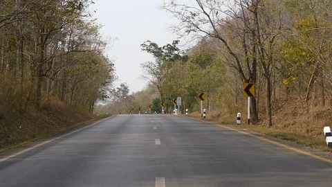 country side curve road with arrow sign | Stock Video | Pond5