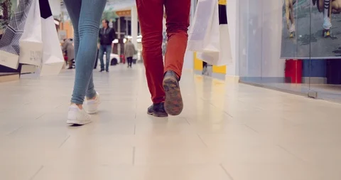 Couple with bags go to the mall. Feet cl... | Stock Video | Pond5