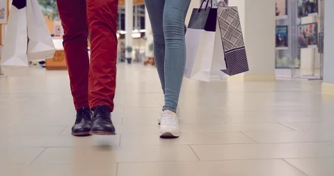 Couple with bags go to the mall. Feet cl... | Stock Video | Pond5