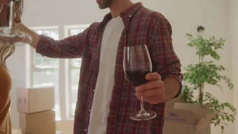Couple Dance and Drink Wine in New Home | Stock Video | Pond5