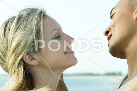 Couple face to face, smiling at each other, side view Stock Image #42262391