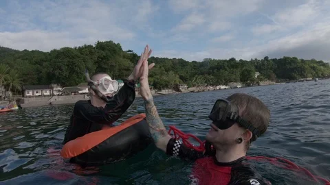 A couple gives high fives while snorkeli... | Stock Video | Pond5