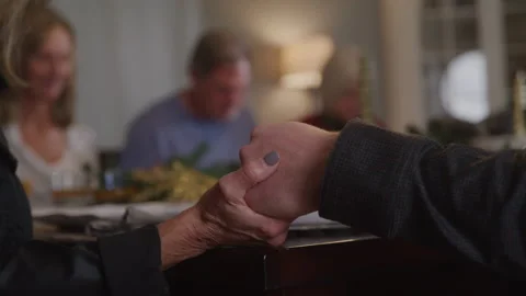 Couple Grabbing Each Others Hands at Fam... | Stock Video | Pond5