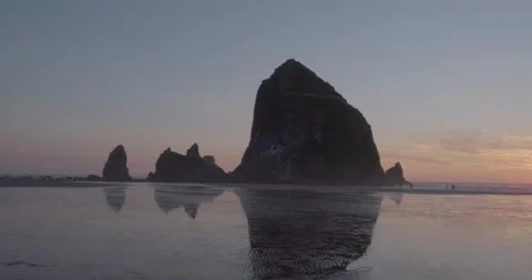 Couple at Haystack rock with sunset, Can... | Stock Video | Pond5