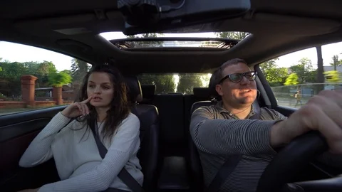 Couple laughing and cuddling in car driv... | Stock Video | Pond5