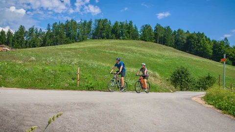 Couple riding bike in the countryside, ... | Stock Video | Pond5