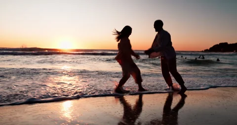 Couple, running and hug by beach in suns... | Stock Video | Pond5