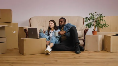 Couple is sitting comfortably on the flo... | Stock Video | Pond5