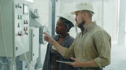 Couple of Technicians Talking by Electri... | Stock Video | Pond5