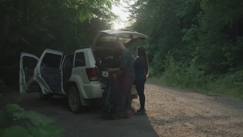 Couple Unloading SUV In Nature | Stock Video | Pond5