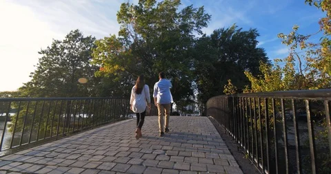 Couple Walks Over Bridge in Beautiful Ci... | Stock Video | Pond5
