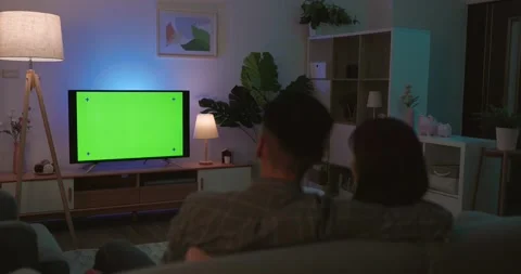 couple watch green screen TV | Stock Video | Pond5