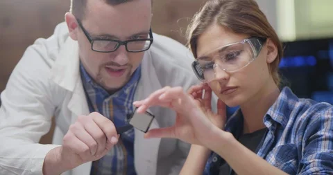 Couple of young engineers looking at mic... | Stock Video | Pond5
