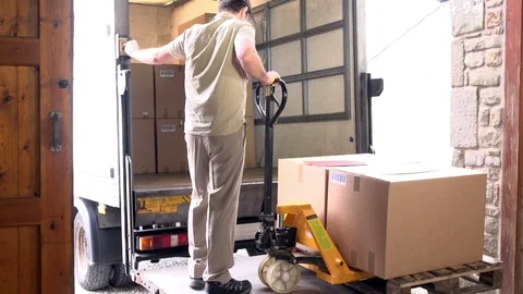 Courier loading a pallet of parcels into... | Stock Video | Pond5