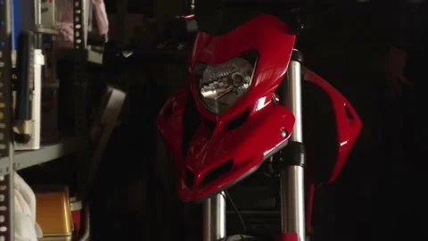 covering a motorcycle under a cover in a... | Stock Video | Pond5