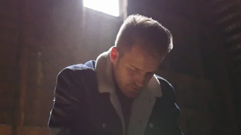 Cowboy Sits Praying In Barn | Stock Video | Pond5