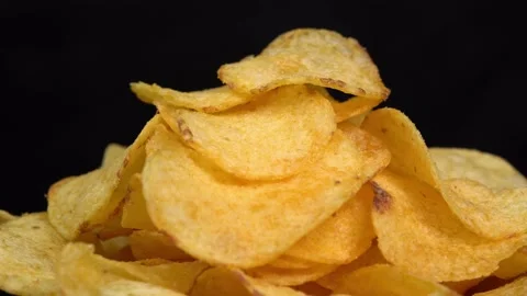 Craft crispy potato chips rotating on bl... | Stock Video | Pond5