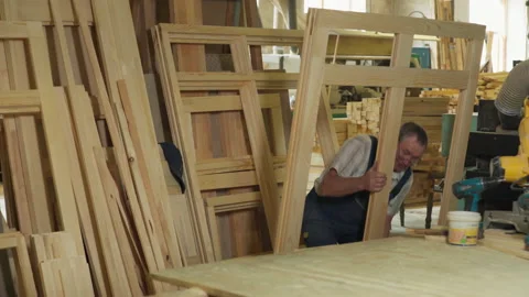 Craftsman is placing the wood window fra... | Stock Video | Pond5