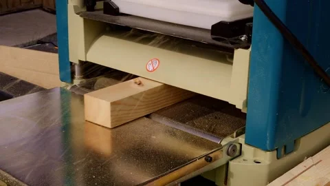 A craftsman plans wooden block on machin... | Stock Video | Pond5