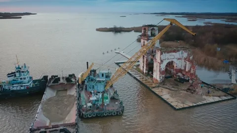 A crane on a floating platform unloads s... | Stock Video | Pond5