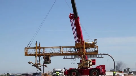 Crane "flying" in road construction equi... | Stock Video | Pond5