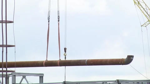The crane hooked a large metal pipe. | Stock Video | Pond5