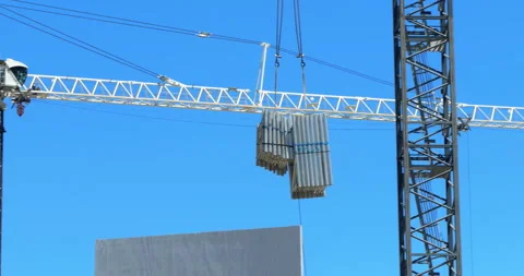 Crane lifting building materials at cons... | Stock Video | Pond5