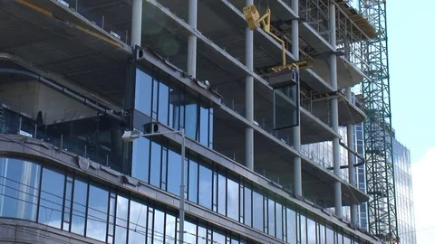 crane lifting facade at construction sit... | Stock Video | Pond5