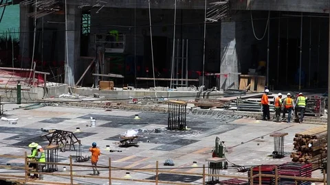 A crane lifts a heavy object as construc... | Stock Video | Pond5