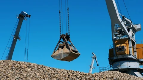 A crane moves rubble in a bucket. | Stock Video | Pond5
