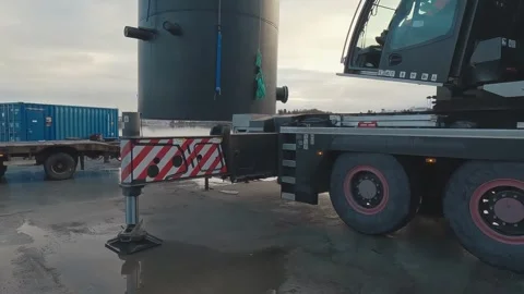 Crane pulls a large tank from a truck tr... | Stock Video | Pond5