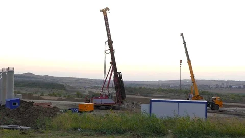 cranes push piles into the ground | Stock Video | Pond5