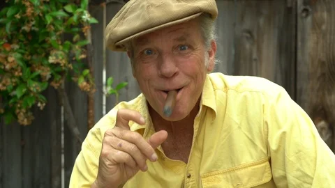 Crazy and funny old man wiggling cigar i... | Stock Video | Pond5
