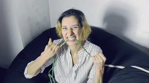 crazy woman biting the rope | Stock Video | Pond5