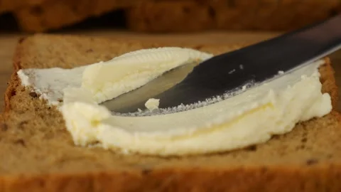 Cream cheese spread with a knife on a pi... | Stock Video | Pond5