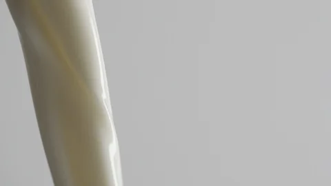 Cream pouring out on white background in... | Stock Video | Pond5