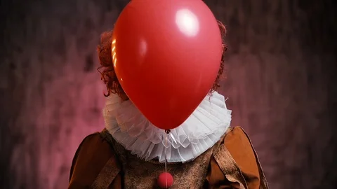 Creepy clown releases a red ball and sho... | Stock Video | Pond5