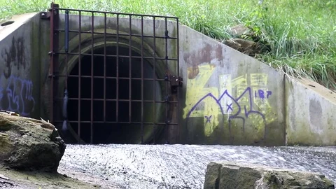 Creepy drainage pipe entrance with graff... | Stock Video | Pond5