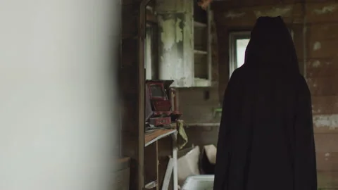 Creepy Figure in Black Cloak Stands in A... | Stock Video | Pond5