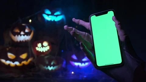 Creepy skeleton hand holding phone with ... | Stock Video | Pond5
