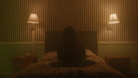 Creepy Woman Sitting On The Bed In A Dar... | Stock Video | Pond5