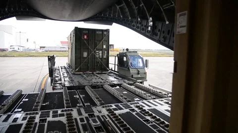 Crew unload military vehicle from Boeing... | Stock Video | Pond5