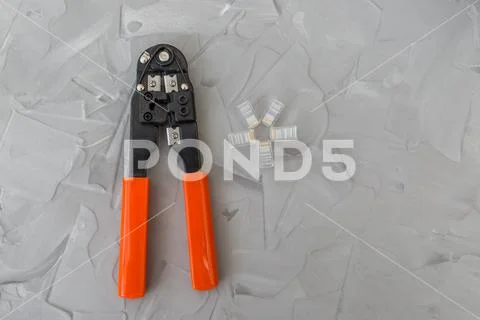Stock Photograph: Crimping RJ45 LAN cable ~ Image #129978722