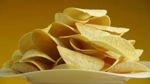 Crispy potato chips rotating on a plate ... | Stock Video | Pond5