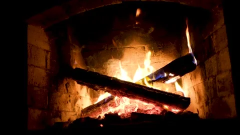 a cross of burning logs in the fireplace... | Stock Video | Pond5